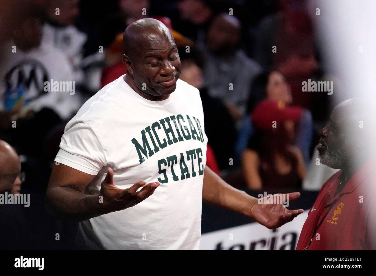 Former NBA player Magic Johnson, left, gestures during the second half ...