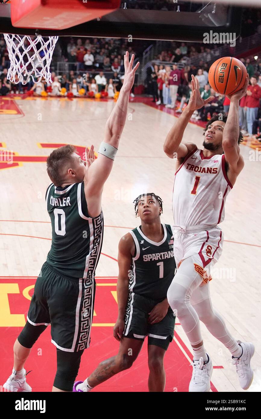 Southern California guard Desmond Claude, right, shoots as Michigan ...