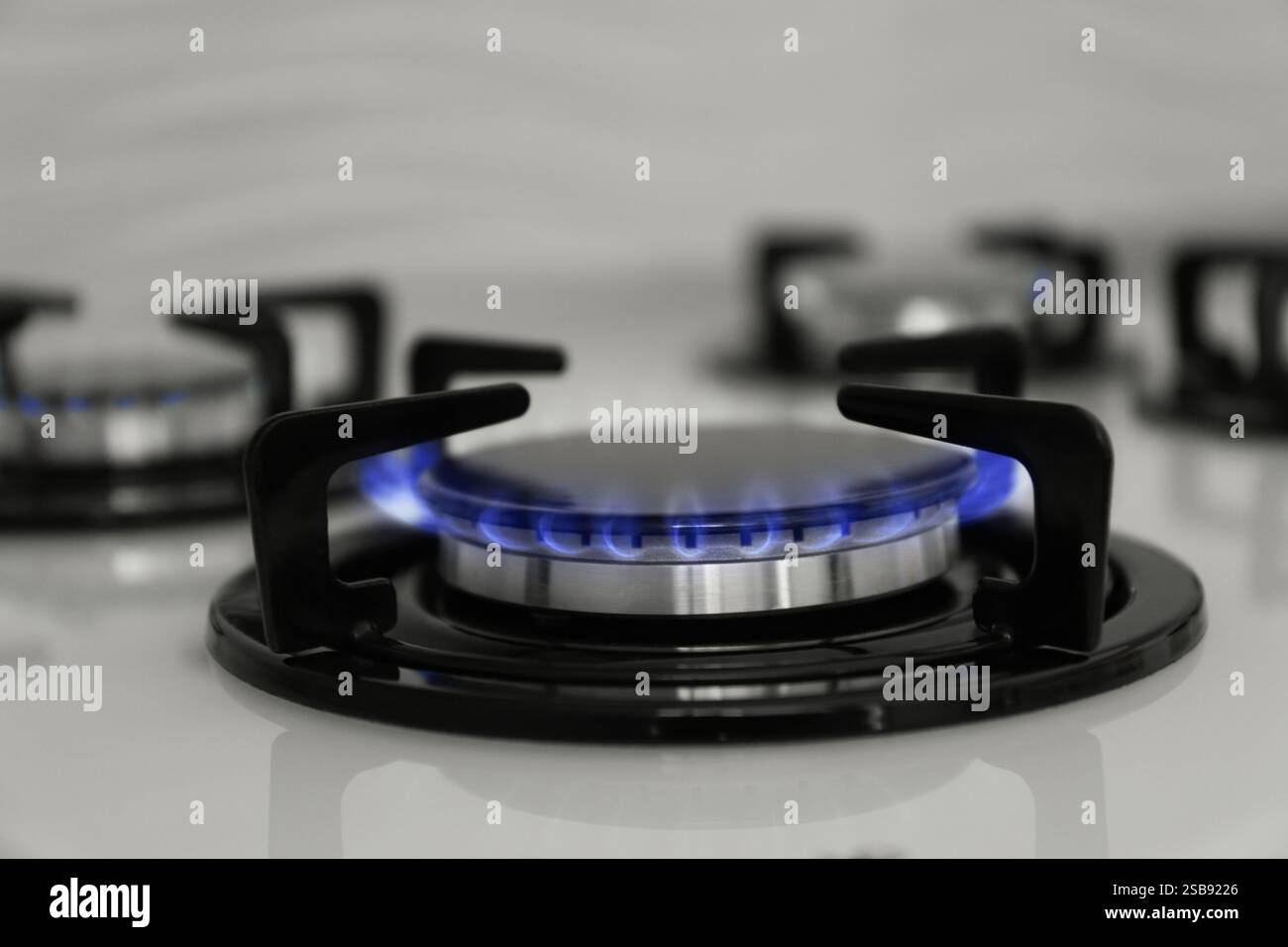 Gas burner of modern stove with burning blue flame, closeup Stock Photo ...