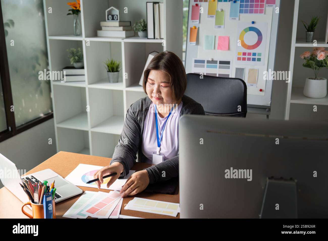 Graphic designer engaged in color selection and project planning in a ...