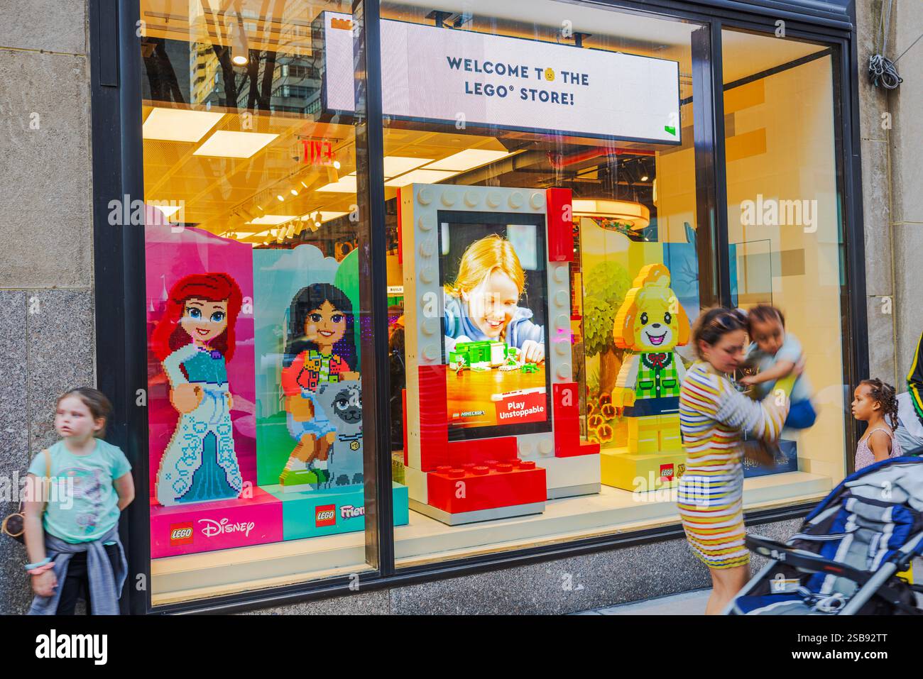 Lego store window display with colorful character figures and digital ...