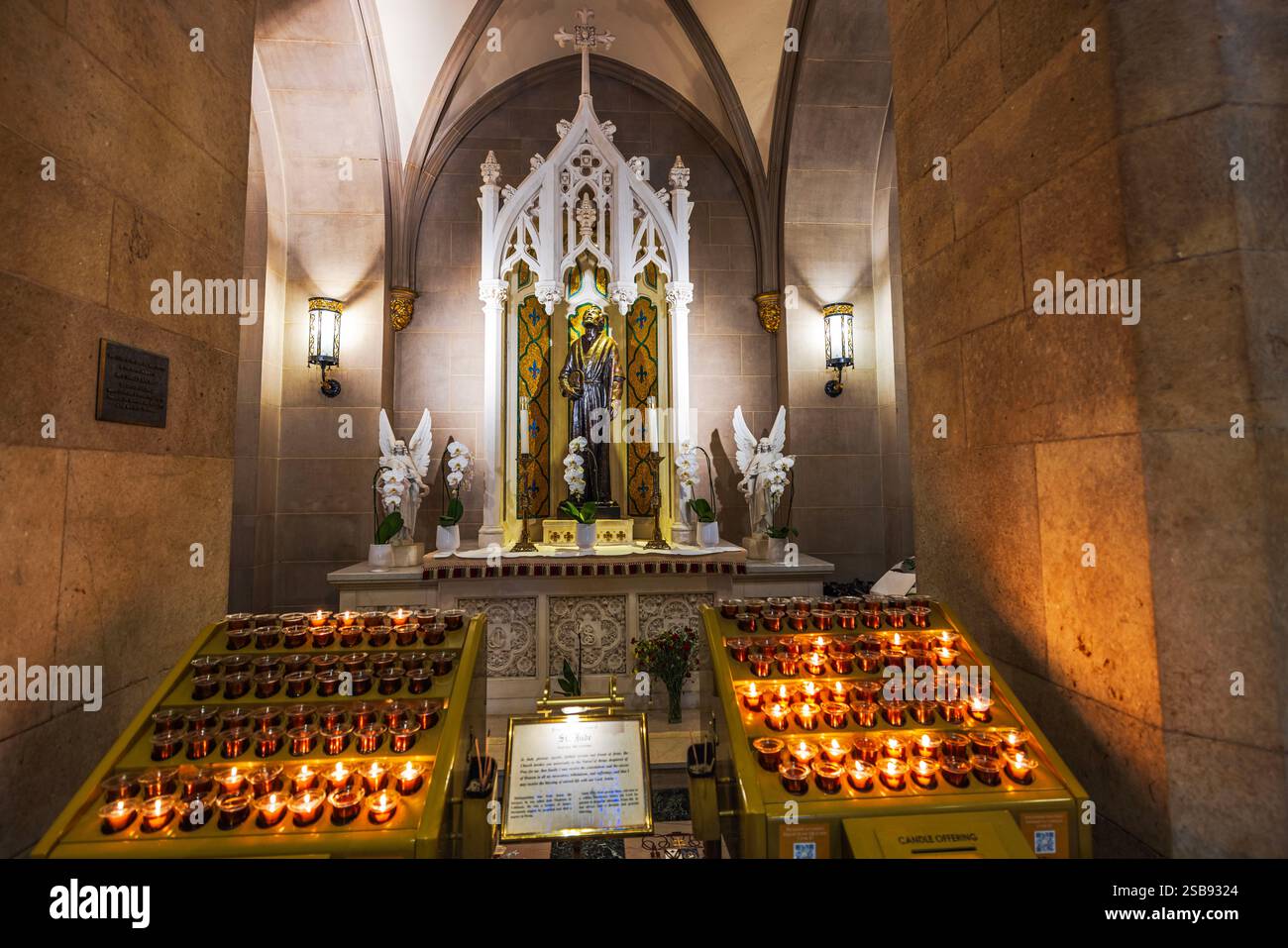 Statue of Saint Jude with burning candles in chapel inside St. Patrick ...