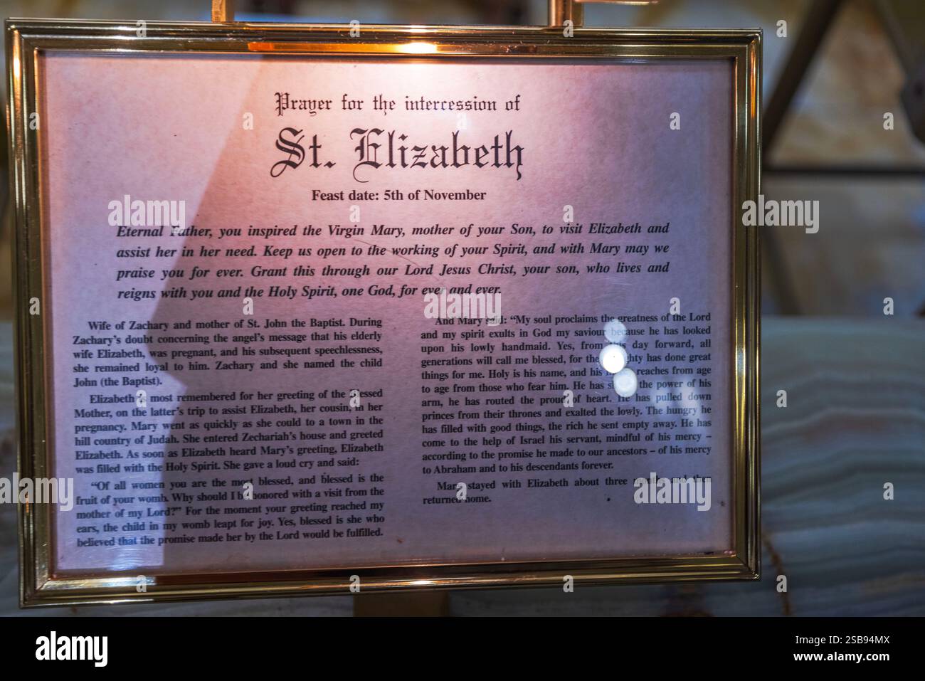 Prayer plaque dedicated to St. Elizabeth, featuring engraved text and golden frame inside St ...