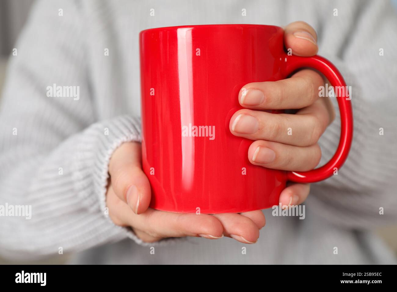 Woman with red ceramic cup, closeup. Mockup for design Stock Photo - Alamy