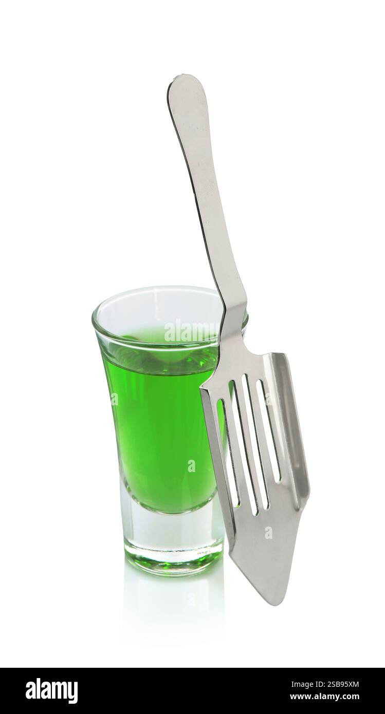 Absinthe in shot glass and slotted spoon isolated on white Stock Photo ...