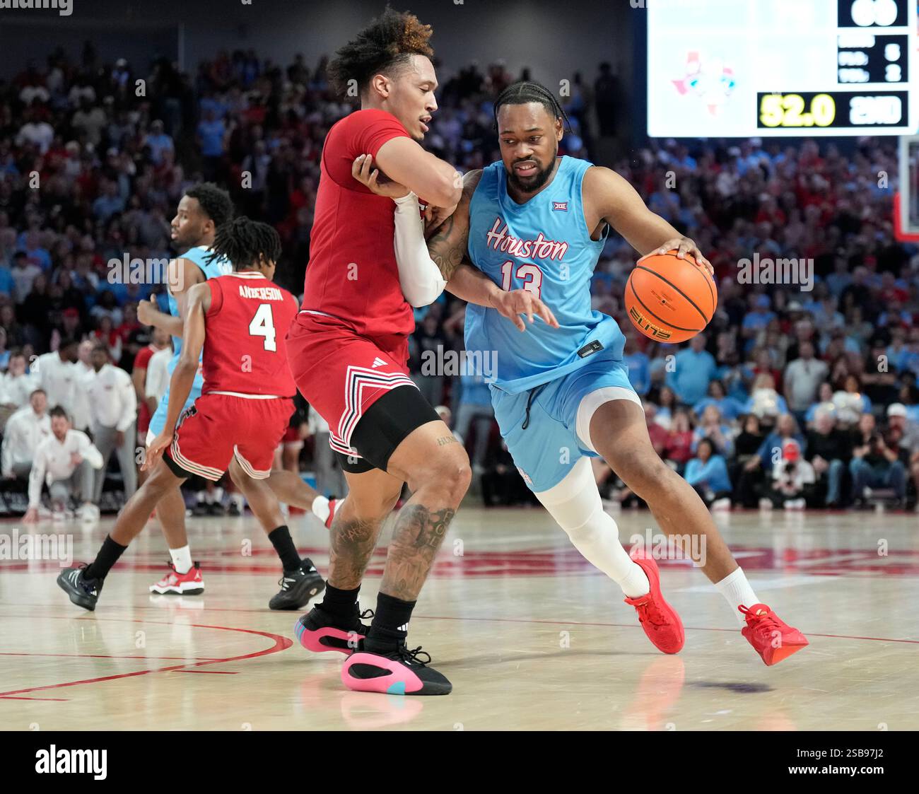 Houston forward J'Wan Roberts (13) drives against Texas Tech forward ...
