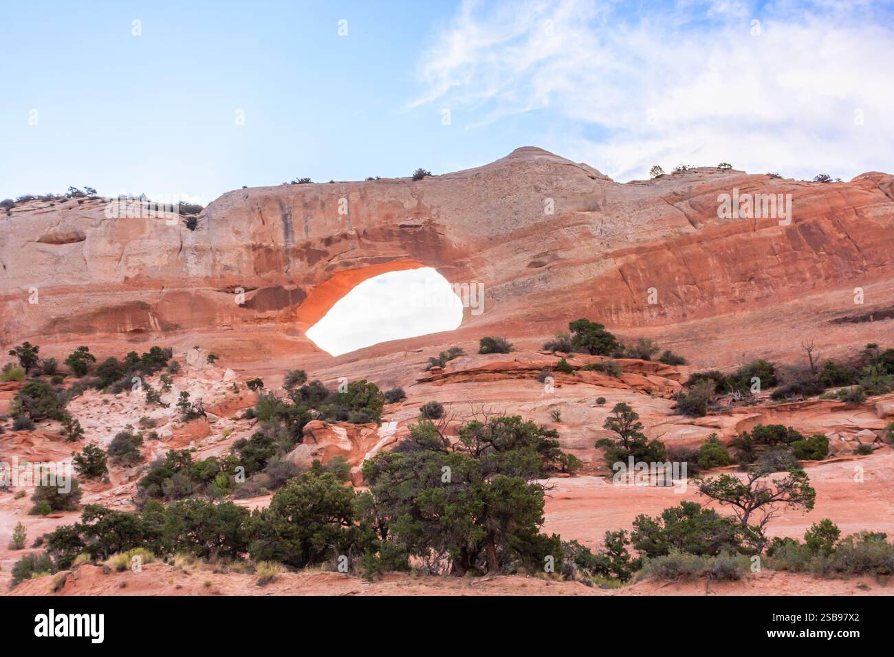 A large rock formation with a large hole in the middle. The hole is ...