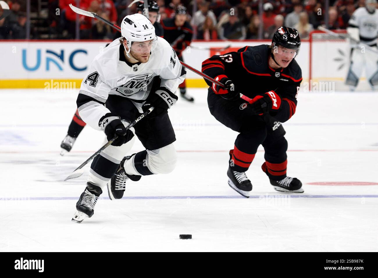 Los Angeles Kings' Alex Laferriere (14) moves the puck away from ...