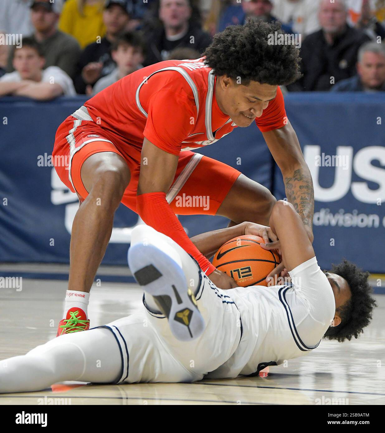 New Mexico guard Tru Washington, top, and Utah State guard Ian Martinez ...