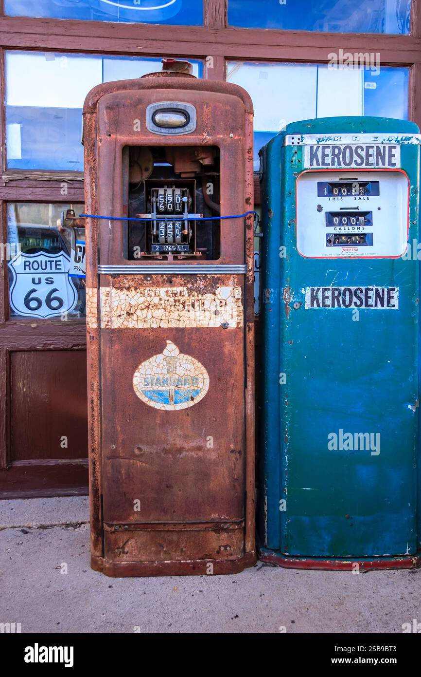 Two old gas pumps, one of which is labeled Kerosene. The pumps are ...