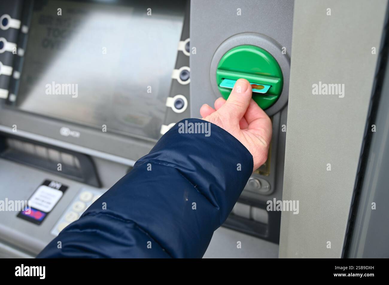 Man is inserting his bank card to the cash machine Stock Photo - Alamy