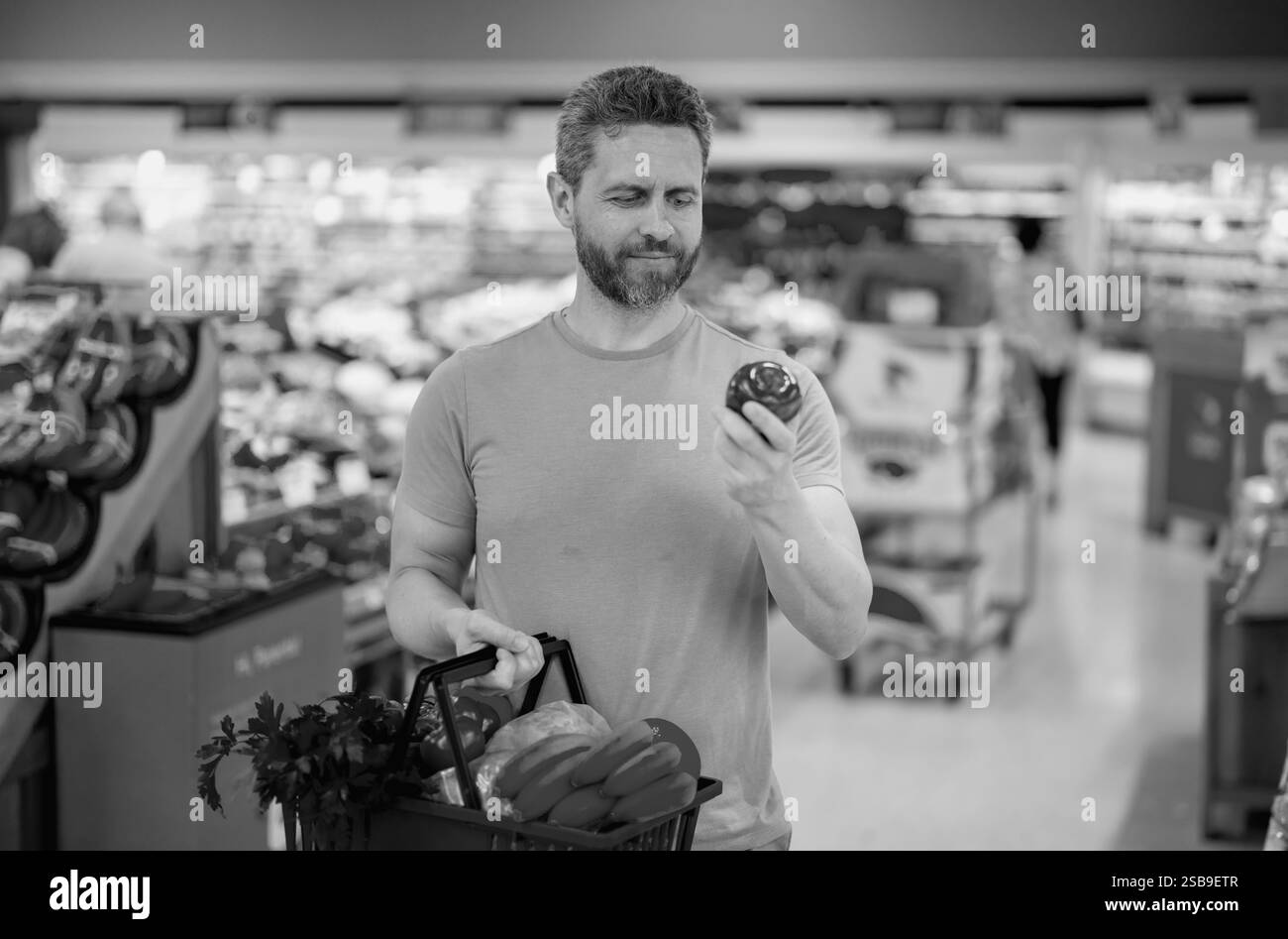 Portrait of man with shopping cart full of fresh vegetables in a food ...