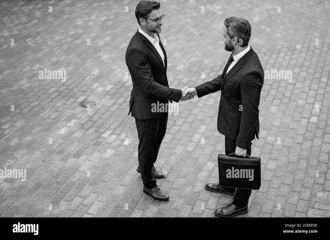 Businessman shaking hands. Two businessmen handshake outdoor. Handshake ...