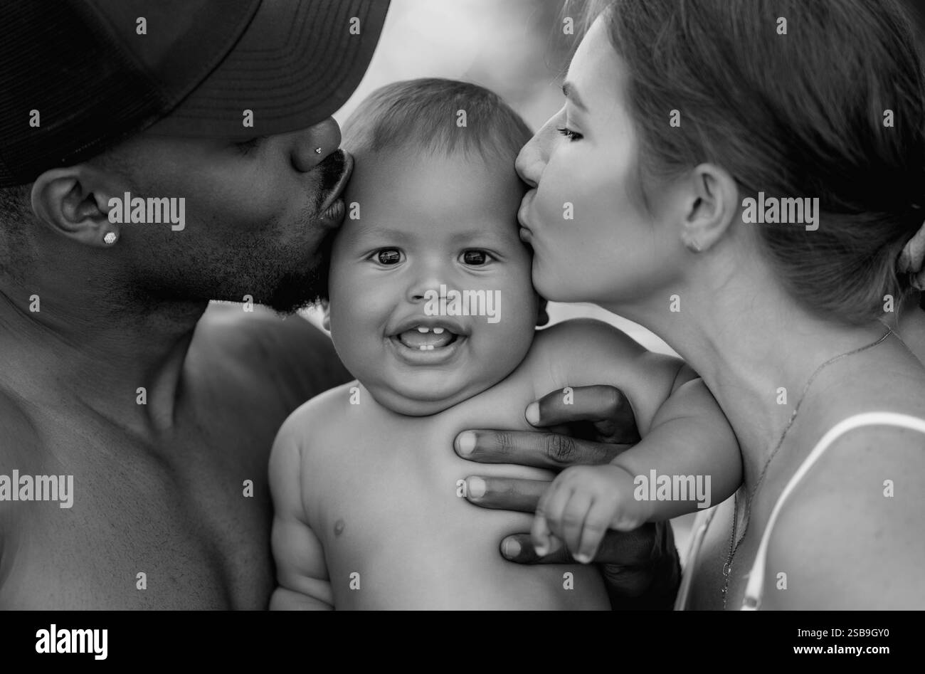 Mothers and father kissed Biracial baby. kissing baby. Mother kiss ...