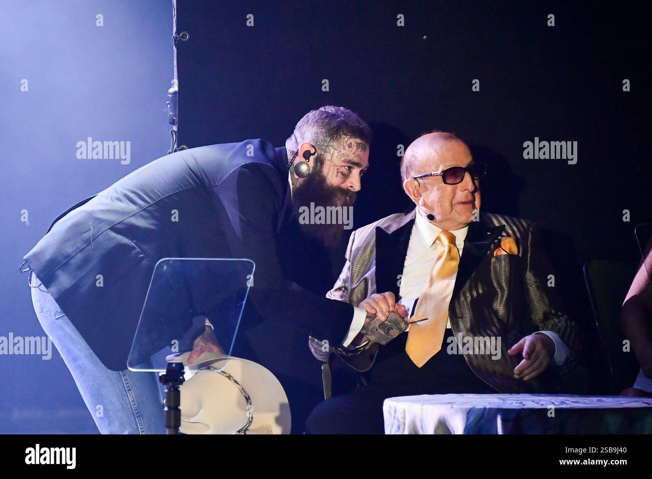 Post Malone, left, and Clive Davis speak during the Pre-Grammy Gala on ...