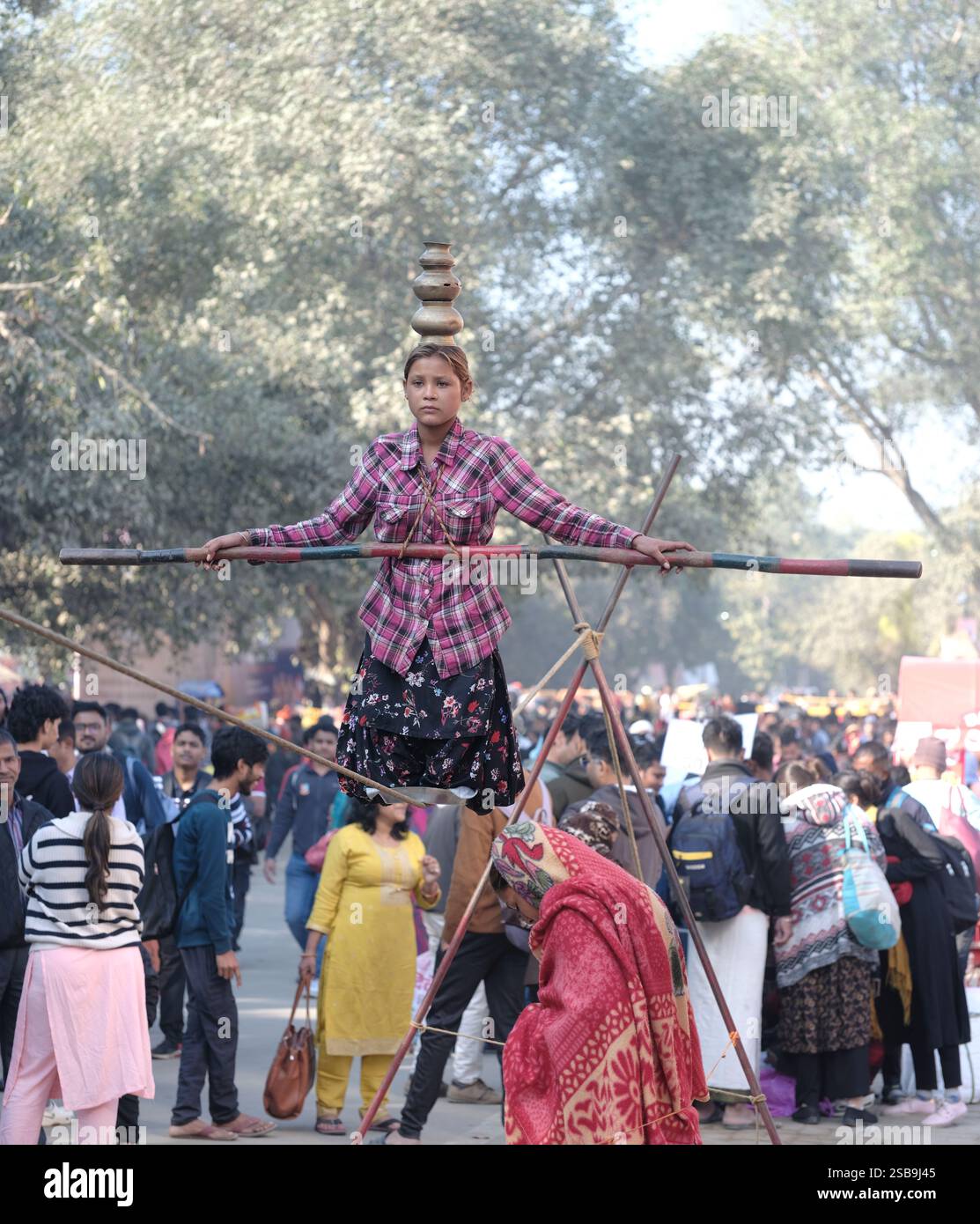 Defying gravity and expectations, the young performer walks the rope at the Maha Kumbh Mela in ...