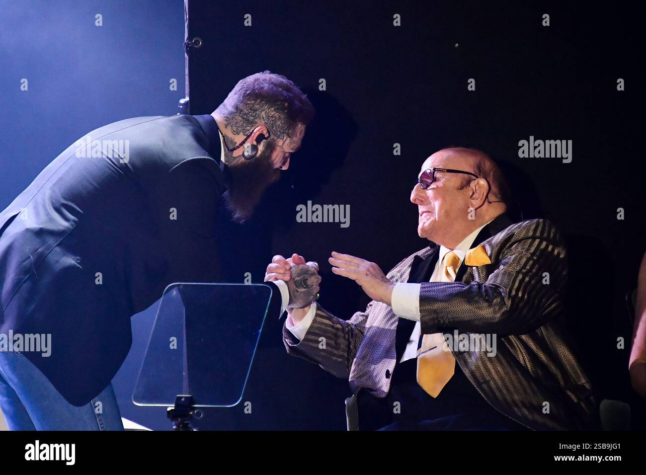 Post Malone, left, and Clive Davis speak during the Pre-Grammy Gala on ...
