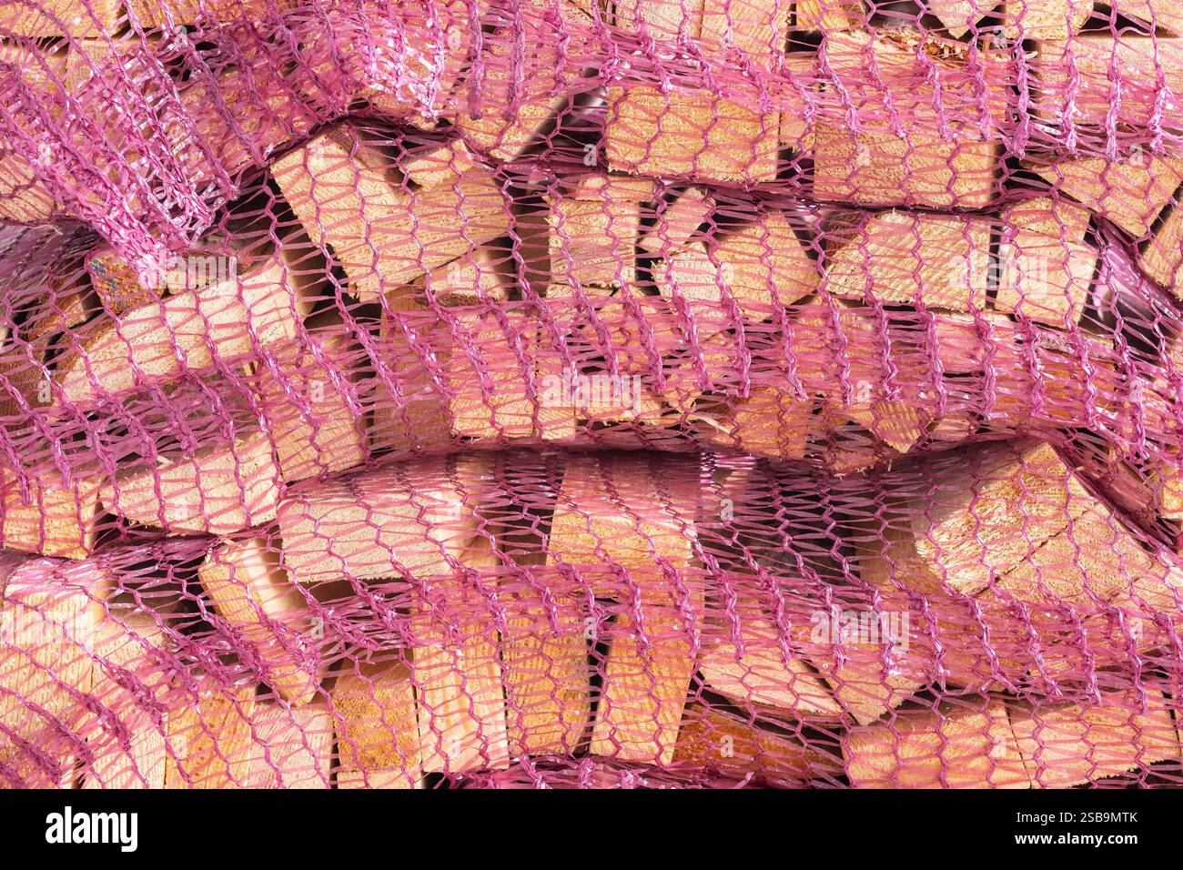 Chopped firewood in a net ready for fire start in fireplaces Stock ...