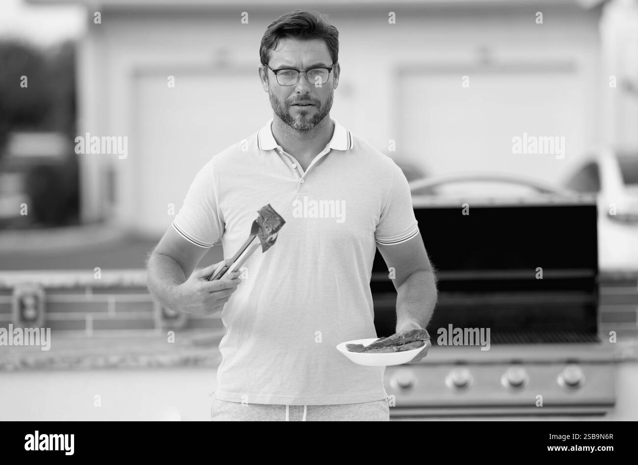 Grill chef cook. Guy with BBQ cooking tools. Barbecue and grill. Picnic ...