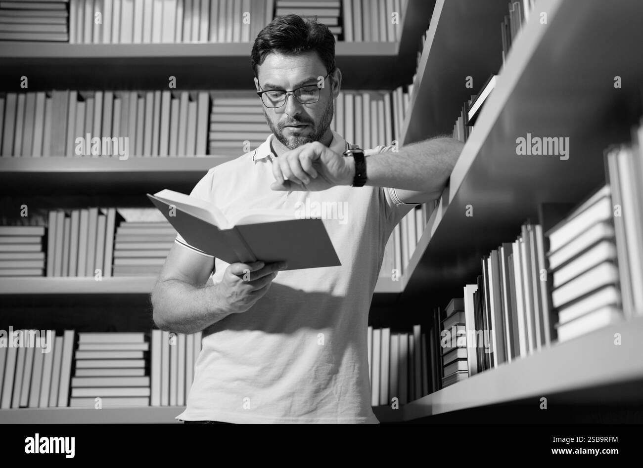 Portrait of professor with book in classroom. Handsome professor in ...