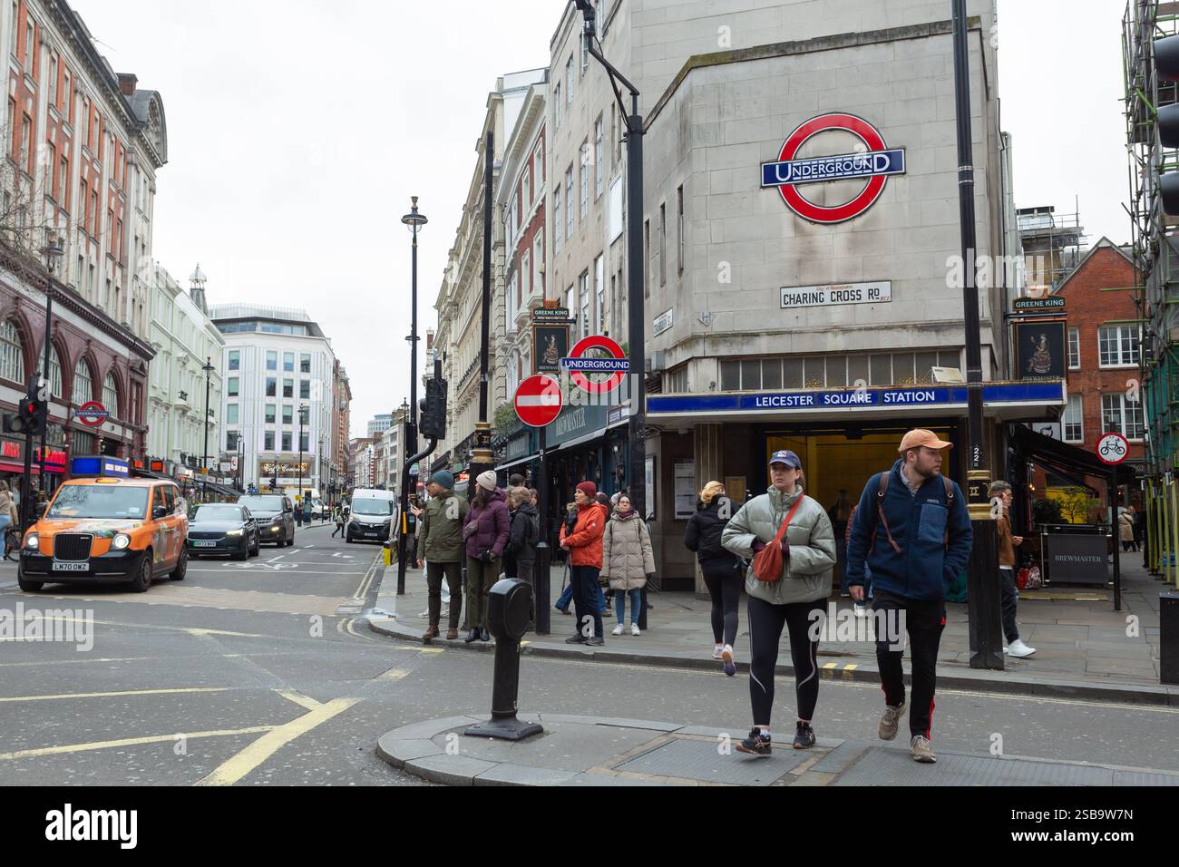 Street view of pedestrians crossing the street outside Leicester Square ...