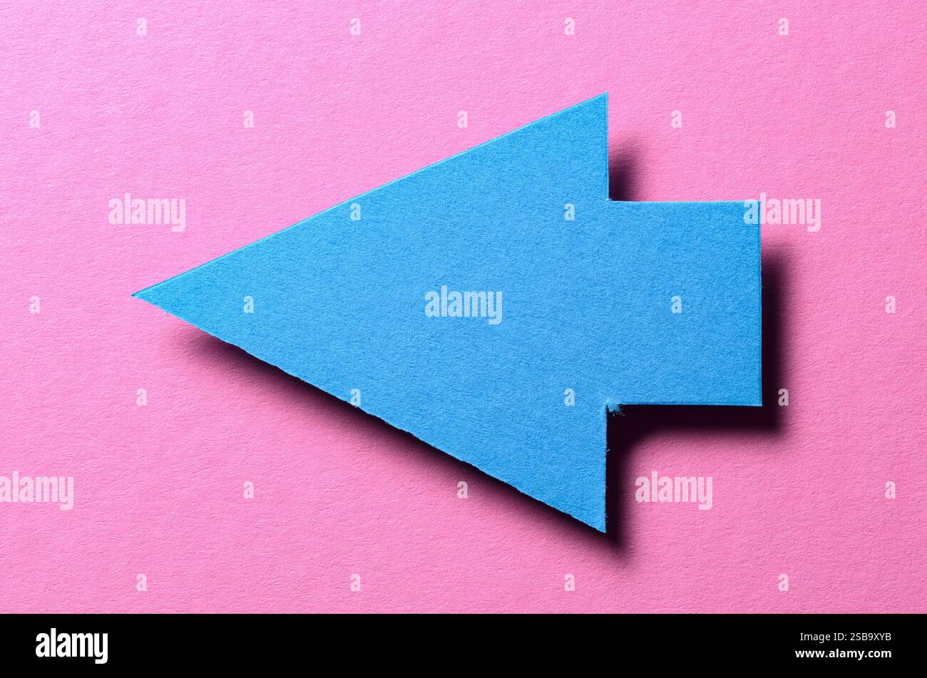 Blue cut out blank paper cardboard arrow direction sign with copy space ...