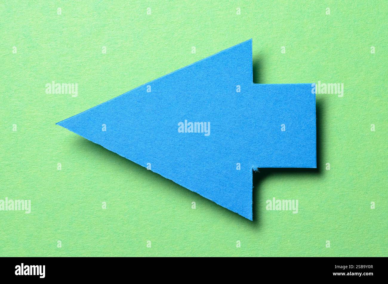 Blue cut out blank paper cardboard arrow direction sign with copy space ...