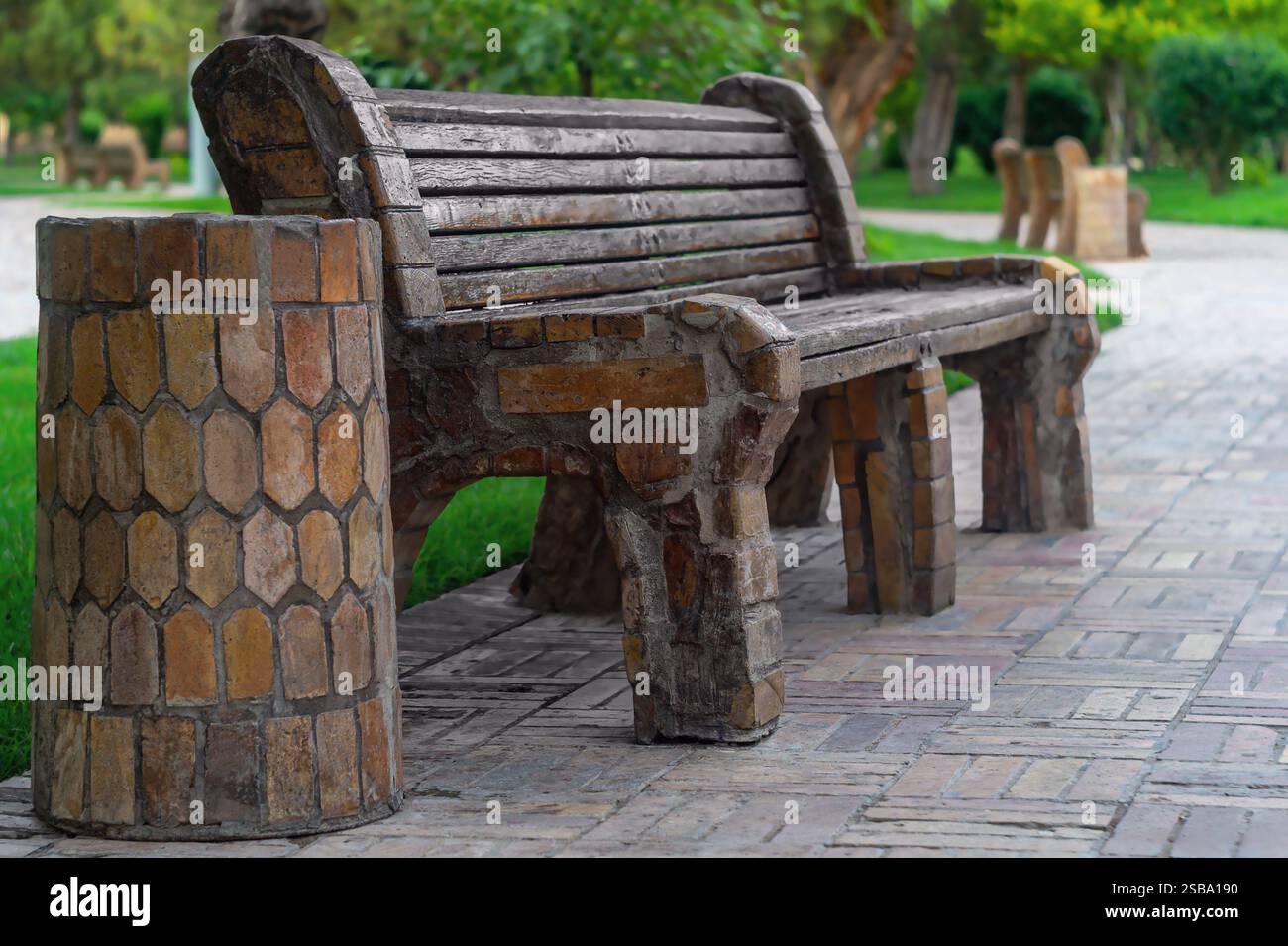 A street park bench made of bricks, cement mortar and textured wood ...