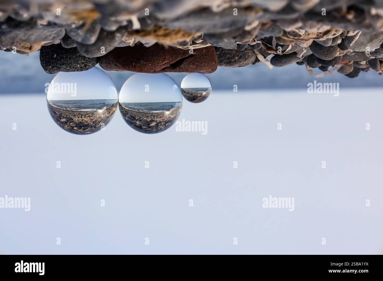 Three Crystal balls, glass spheres, two large and one smaller, resting ...