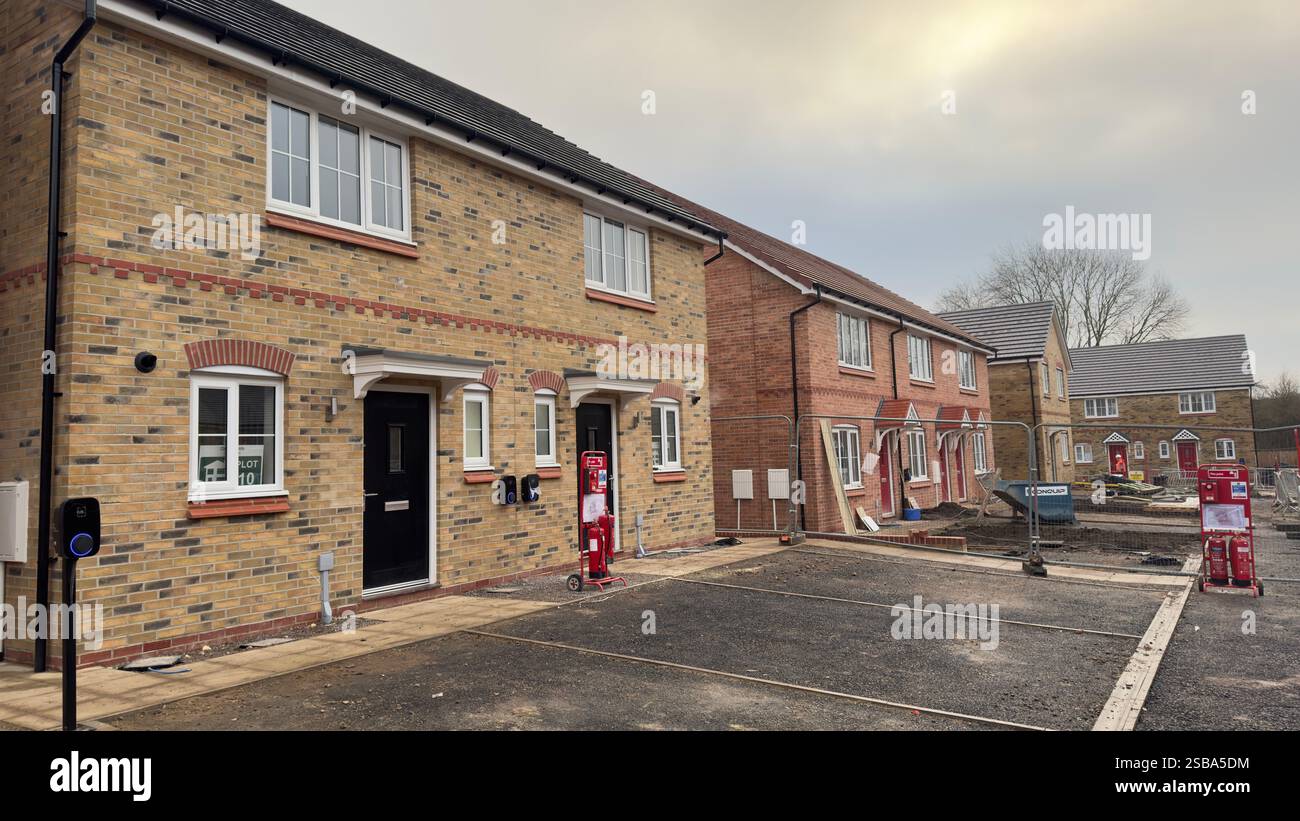 Newly constructed brick townhouses, varying in brick color (tan and red ...