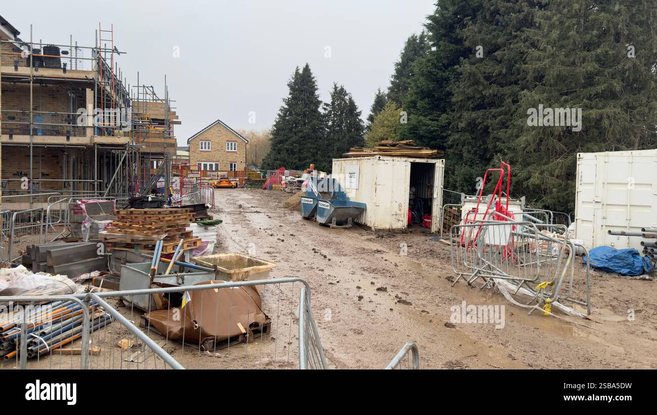 Muddy construction site with partially built houses, scaffolding ...