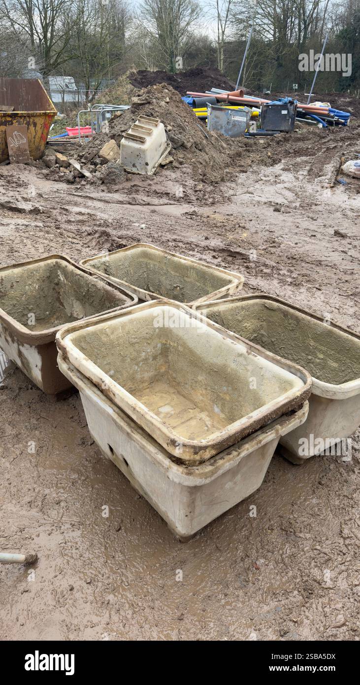 Several stacked, dirty, off-white rectangular plastic containers sit on ...