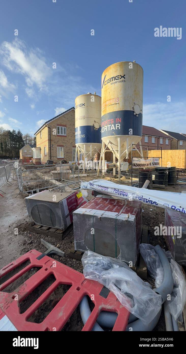 Construction site with two large Cemex mortar silos, new houses ...