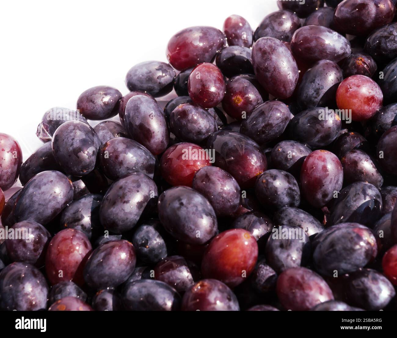 Grapes after washing on a white background. Clean cores of ripe grapes ...