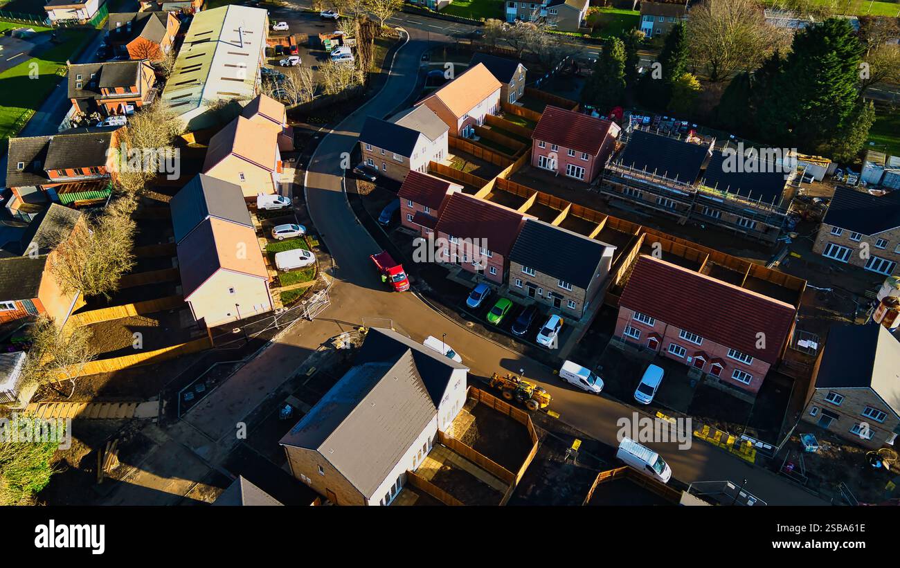 Aerial view of a new housing development. Rows of two-story houses with ...