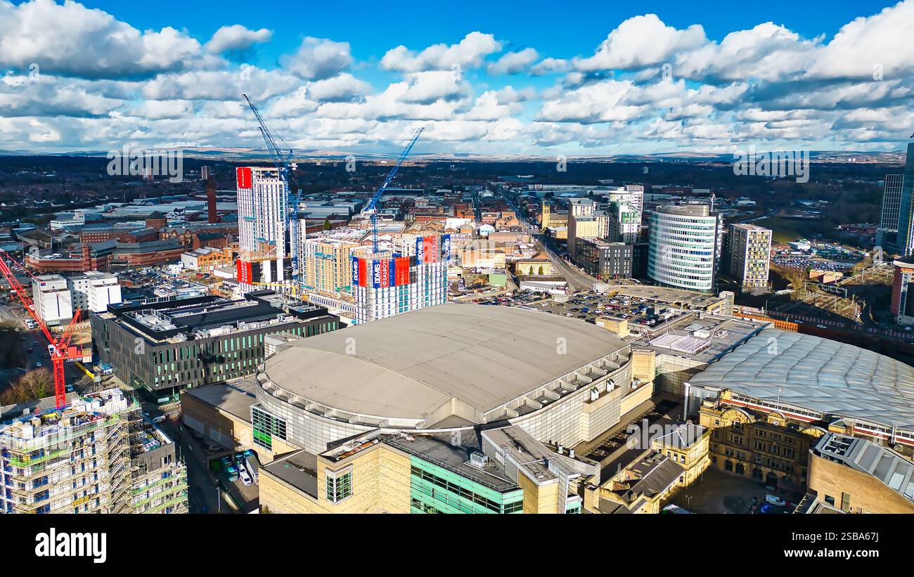 Aerial view of a city landscape featuring a large arena, high-rise ...