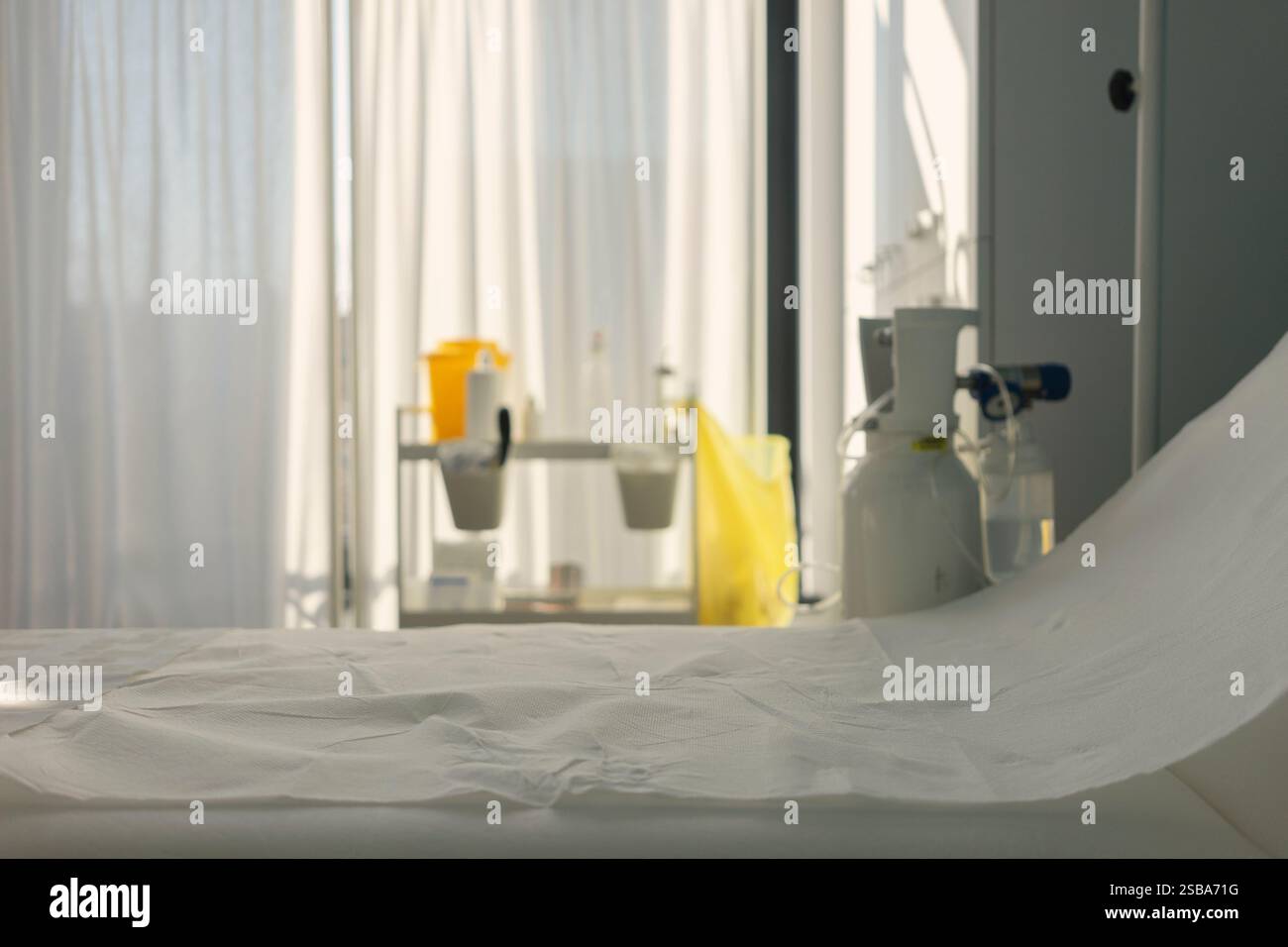 An empty bed prepared for the next patient, in a hospital room with ...
