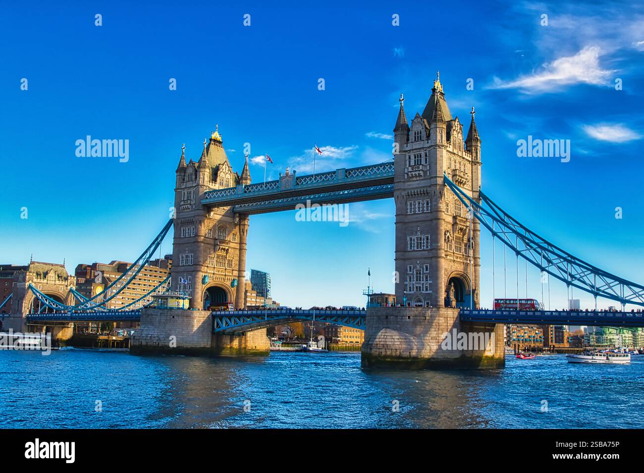Tower Bridge in London, England, spans the River Thames under a vibrant ...