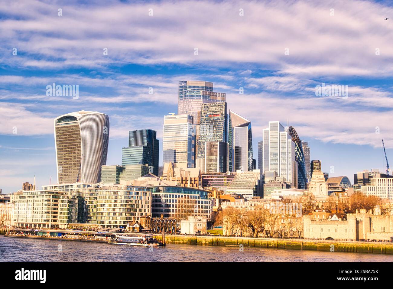 London skyline viewed from across a river, featuring modern skyscrapers ...