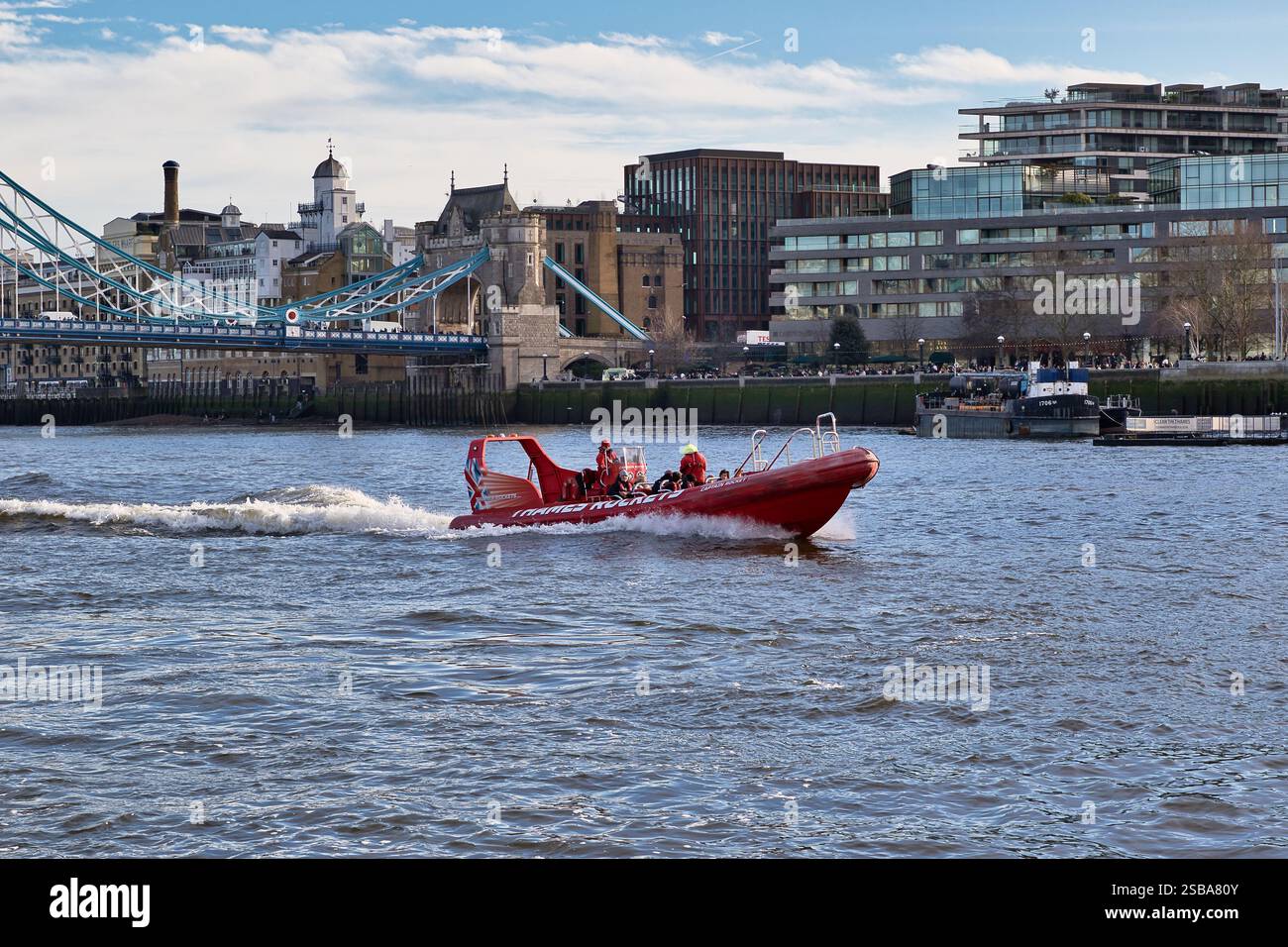 A red Thames Rockets speedboat with passengers travels on the River ...