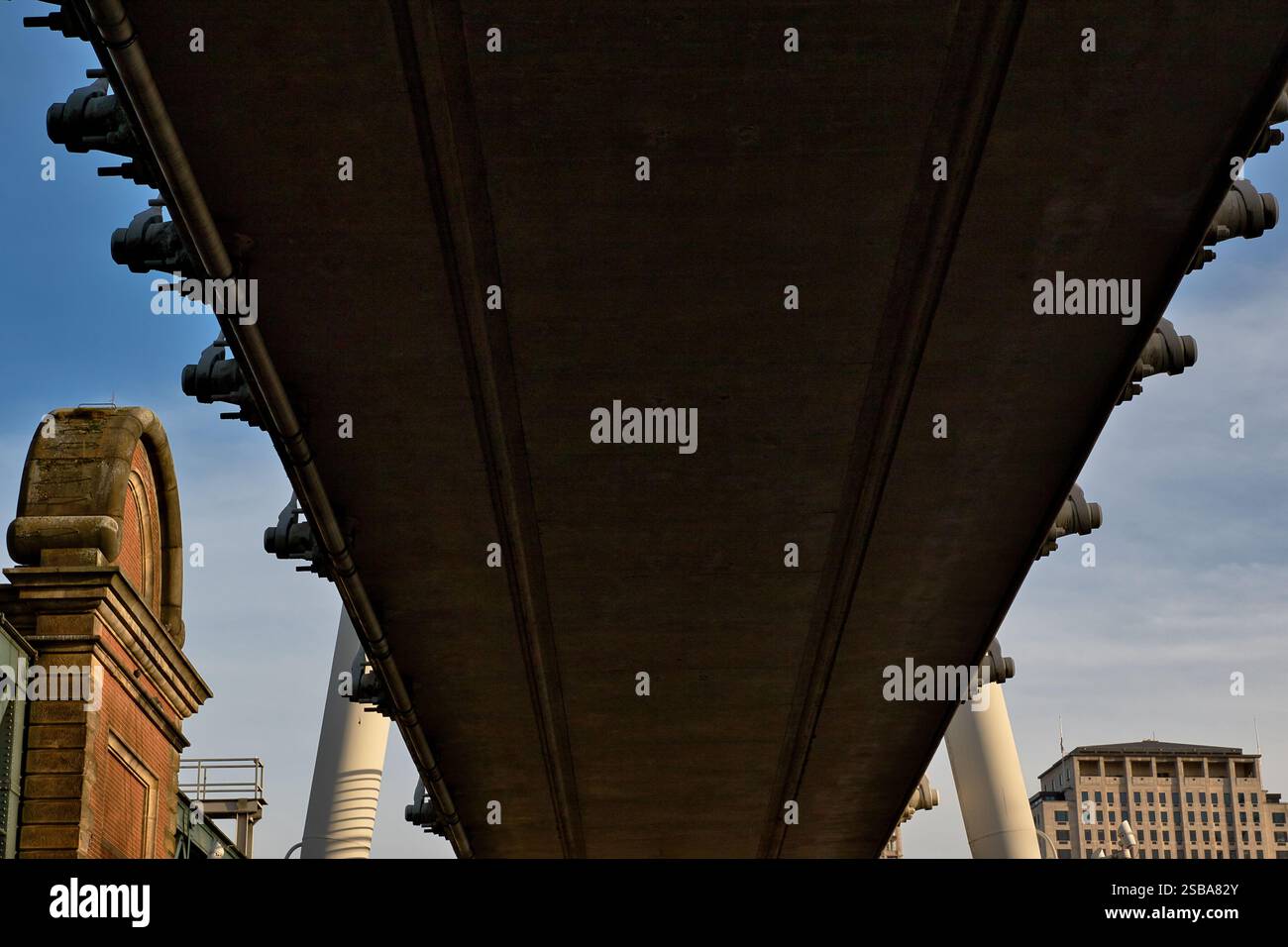 Low-angle view of a bridge's underside, showing its concrete structure ...