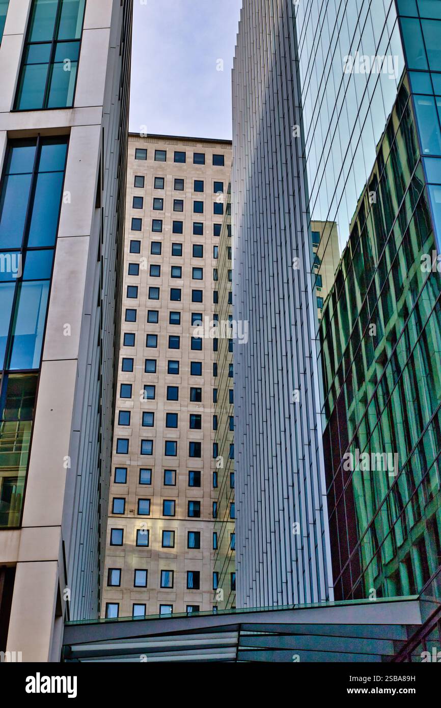 Three modern buildings stand closely together, showcasing contrasting ...