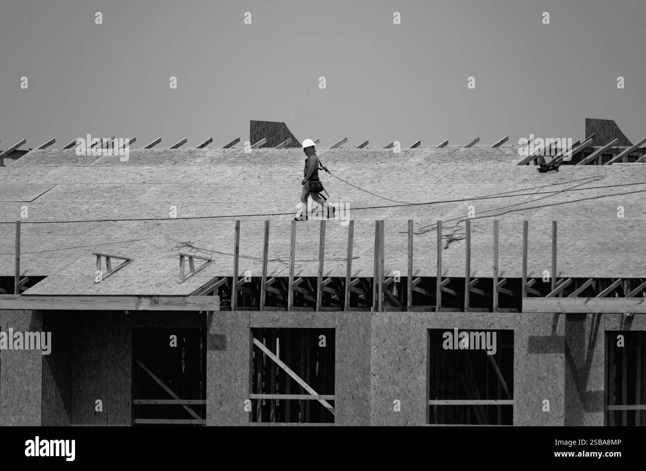 Construction workers on top roof of building Black and White Stock ...