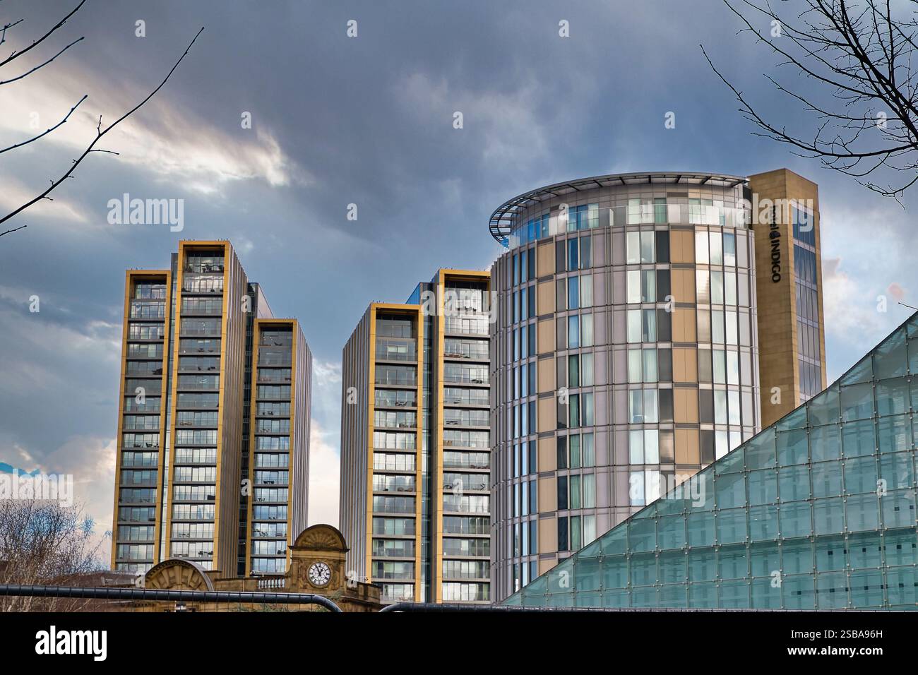 Three modern high-rise buildings, including a curved Hotel Indigo, are ...