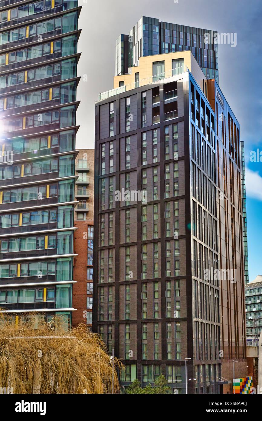 Three modern high-rise buildings stand close together. The central ...