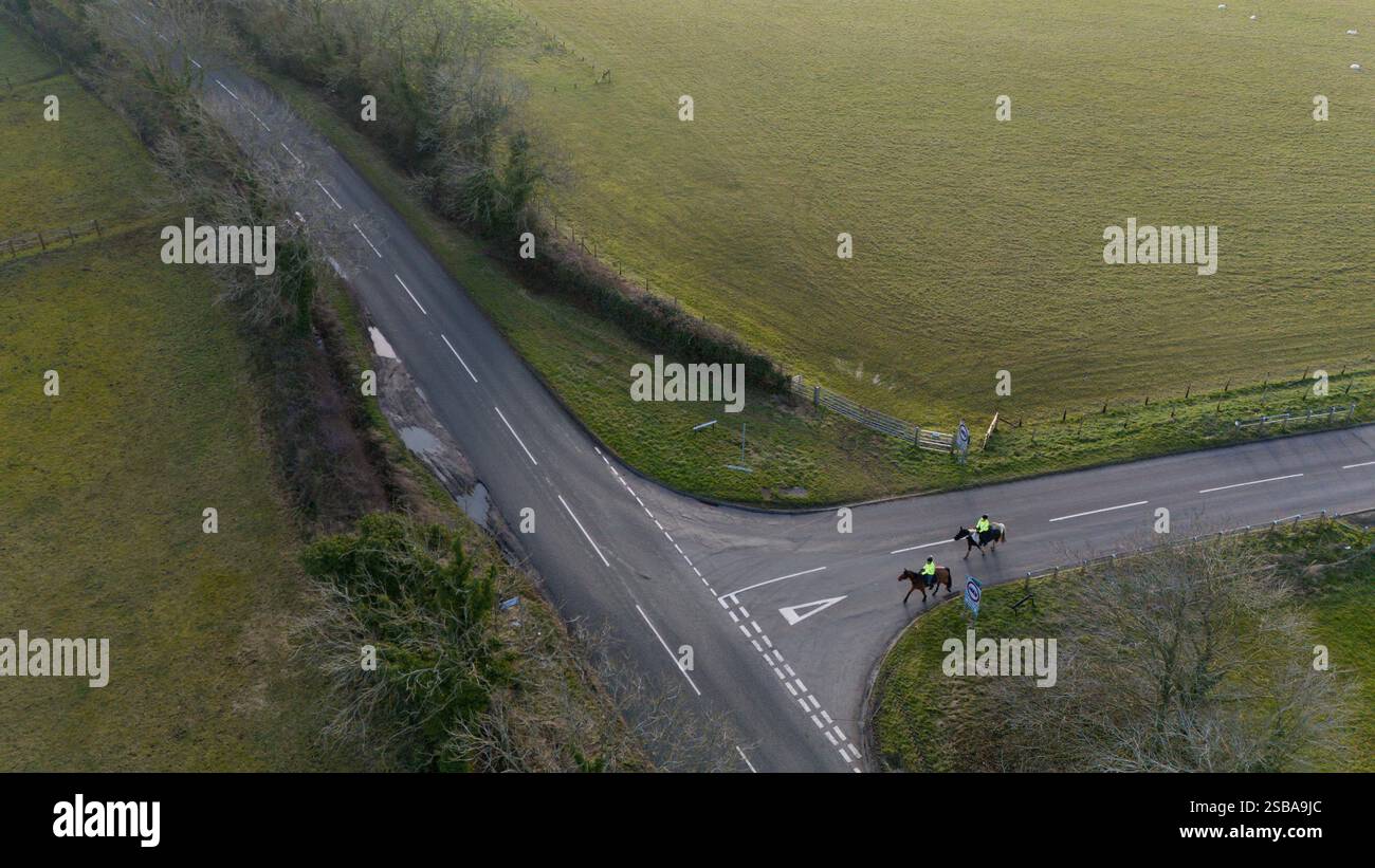 Horse riders during a bright and cold morning in the village of ...