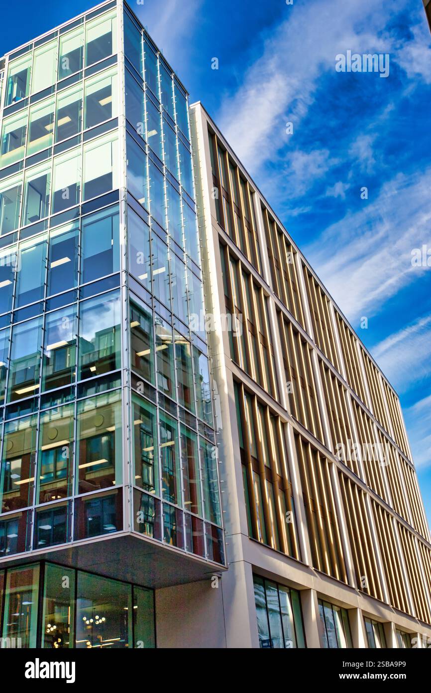 Modern glass and concrete building against a blue sky. The building ...