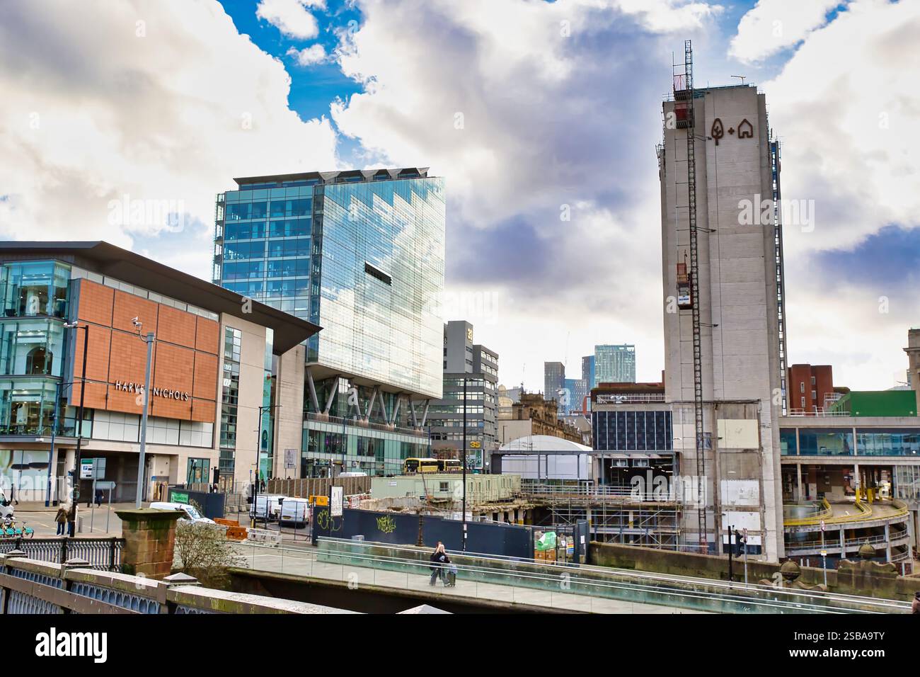 Urban cityscape featuring modern glass buildings, a taller concrete ...