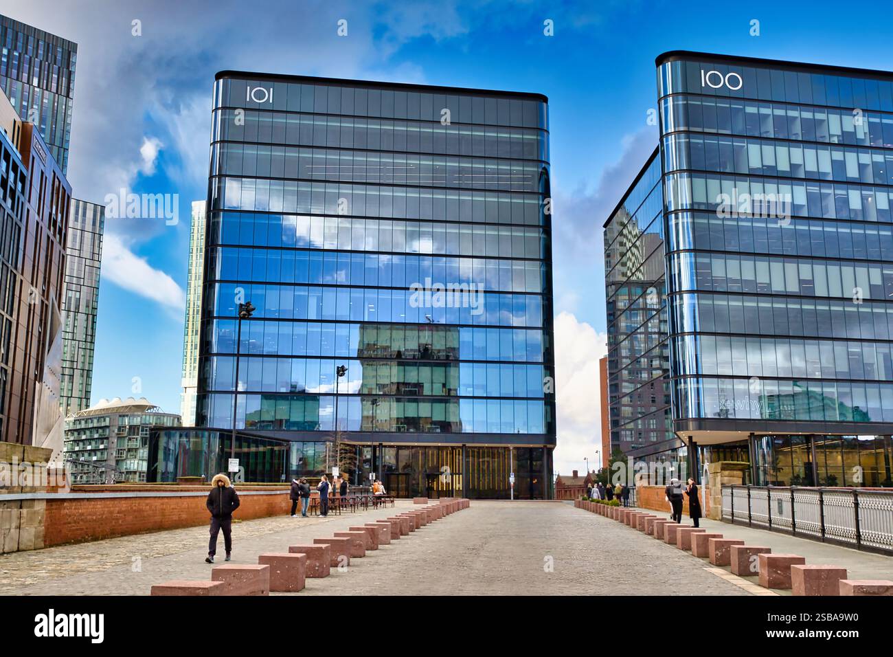 Two modern glass-fronted office buildings, numbered 101 and 100, stand ...