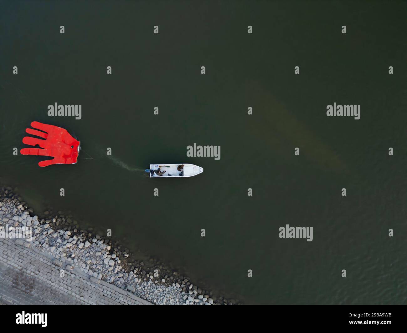 Aerial view of boat pulling red hand. Symbol. Students protest against ...